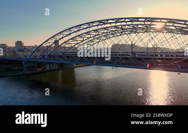 Arched steel bridge over a river at sunset Krakow, Poland. Suburban ...