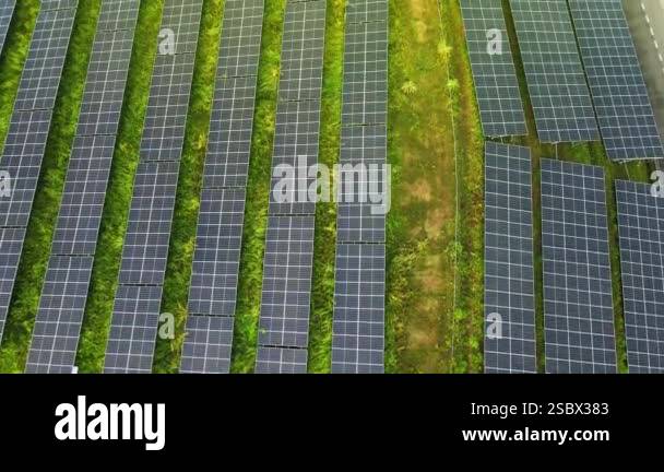 Aerial 4K view of solar panel installations on a landscaped field ...