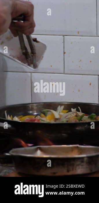 Chef Stir Frying Vegetables in a Flaming Wok in an Outdoors Kitchen ...