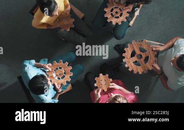 Top view of smart business people joining and gathering wooden gear ...