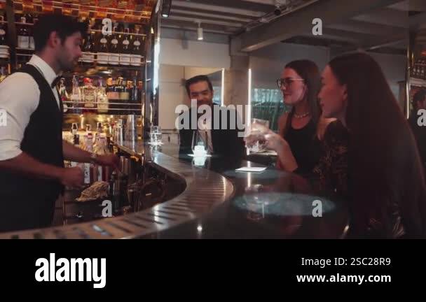 Serving special drink gin fizz of mixed cocktail to smiling VIP ...