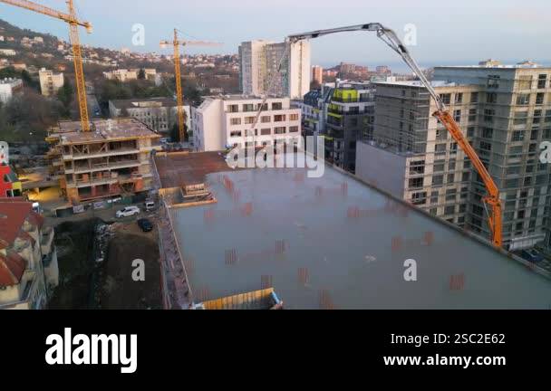 Aerial view of an active construction site featuring a high-rise ...