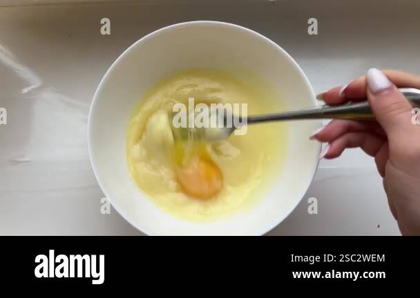 Mixing eggs with a hand mixer, close-up. Cooking in the home kitchen ...