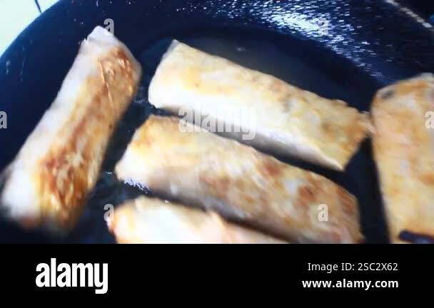fry spring rolls in a pan Stock Video Footage - Alamy