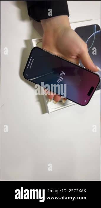 Unbox apple. unboxing new iphone 16 pro. white gadget phone. hands of a ...
