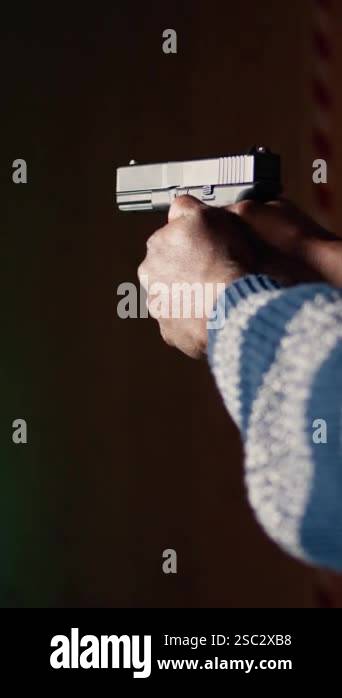 Vertical video Firing range customer doing shooting activity with ...