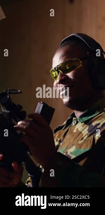 Vertical video Portrait of cheerful soldier doing training in shooting ...