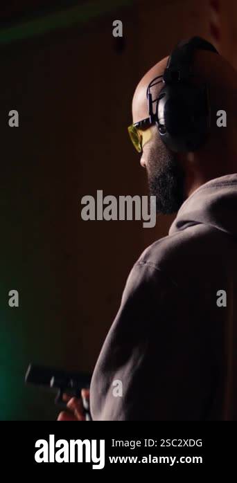 Vertical video Shooting range customer shooting targets with pistol ...