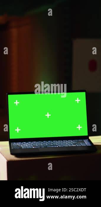 Vertical video Green screen laptop in shooting range next to man ...