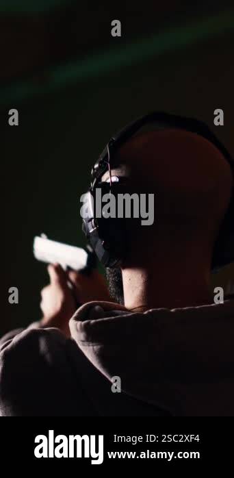 Vertical video Group of friends in firing range doing recreational ...