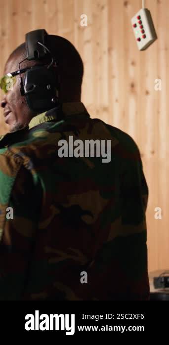 Vertical video Portrait of happy soldier holding assault rifle ...