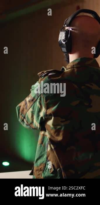 Vertical video Army soldier in shooting range reloads pistol, shooting ...