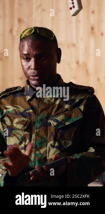 Vertical video Army commander talking with recruits in shooting gallery ...