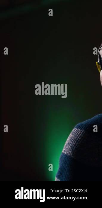 Vertical video Person wearing safety goggles loading pistol bullets ...