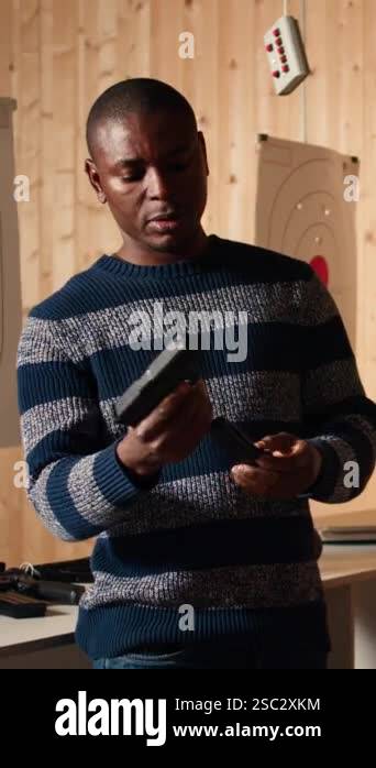 Vertical video Shooting range safety officer demonstrating how to ...