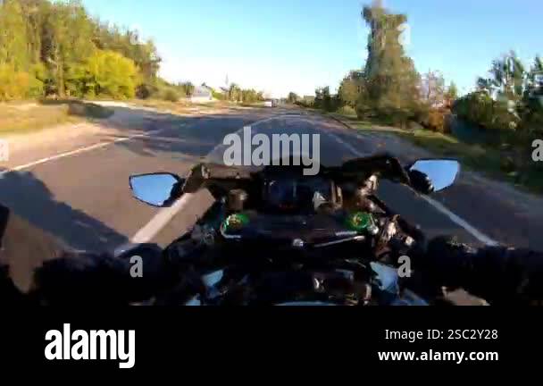 Viewpoint of motorcycle rider driving motorbike at busy suburban route ...