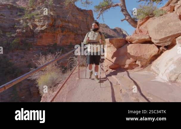 A proud African American man, filled with enthusiasm, hikes in scenic ...
