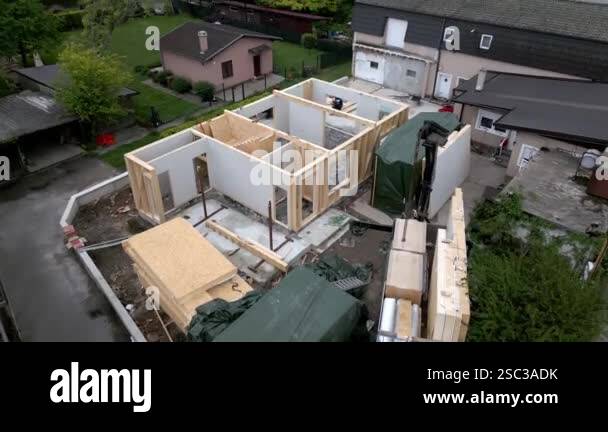 Construction of a prefabricated house with wooden walls being assembled ...