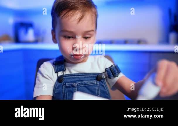 Funny Caucasian baby boy with dairy stains on his face. Portrait of a ...