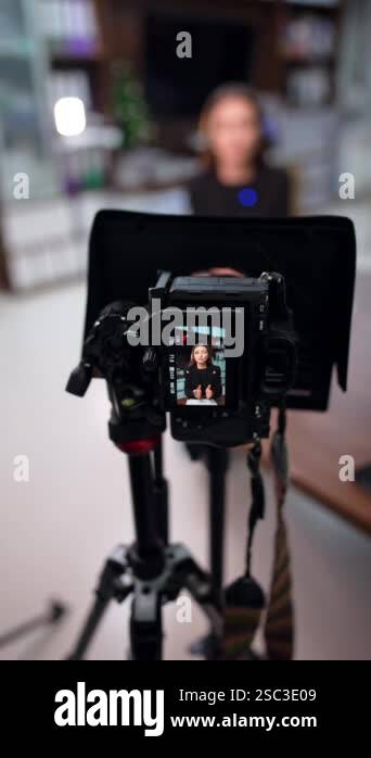 Female influencer on a display of professional camera. High angle view ...