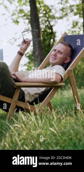 Man took a break from work and laid back in folding chair. Freelancer ...