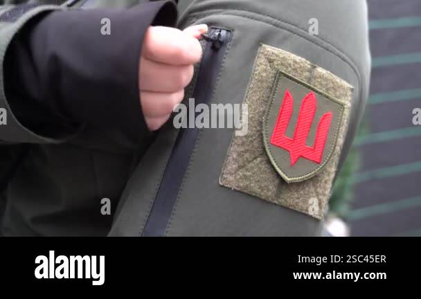 A girl in a military uniform with a manicure holds a military ...