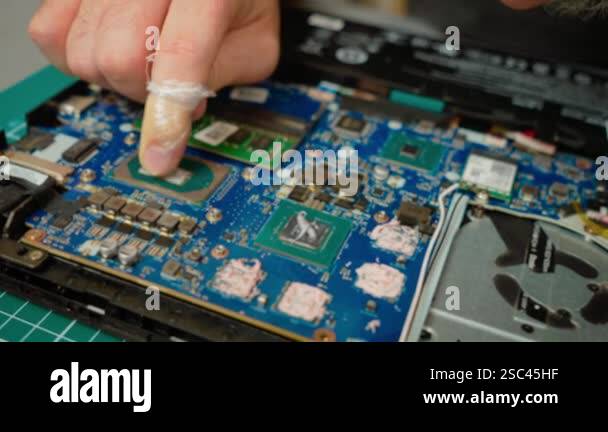Evenly distributing thermal paste on processor during laptop repair ... Evenly distributing thermal paste on processor during laptop repair ...