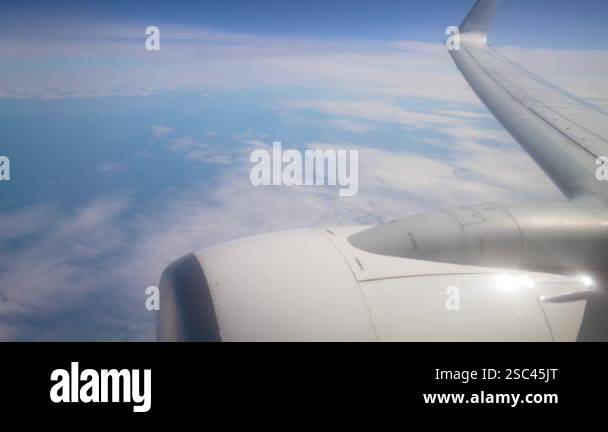 View From Airplane Window Showcasing Engine and Cloud Dotted Sky During ...