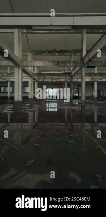 A moody abandoned building interior featuring a large window partially ...