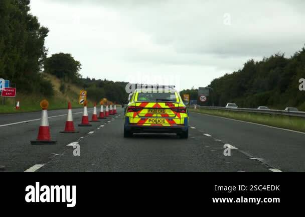 Police car navigating through road cones Stock Video Footage - Alamy