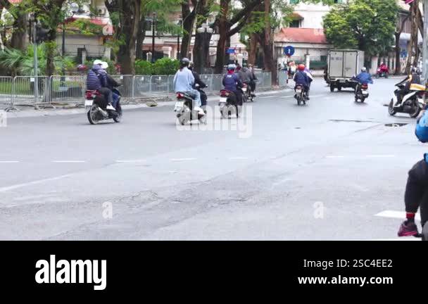 Motorbikes and cars navigate a bustling intersection Stock Video ...