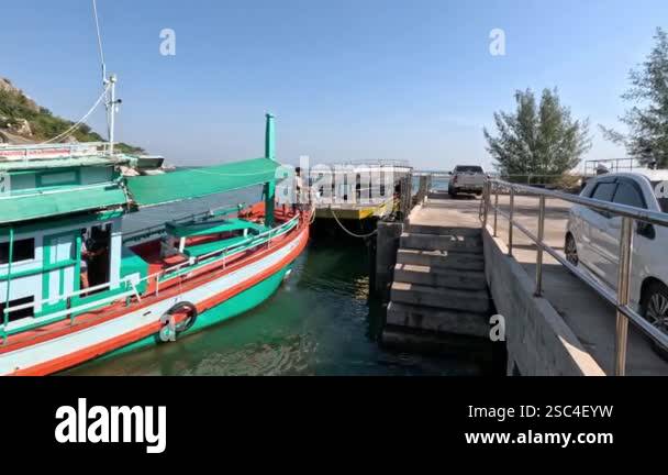 A boat approaches and docks at a pier over time Stock Video Footage - Alamy