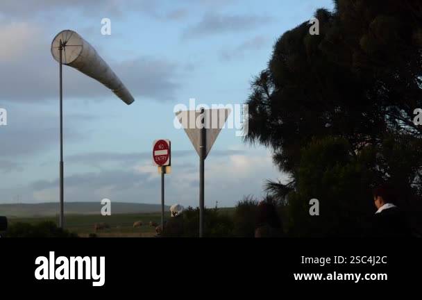 Windsock and road signs in windy conditions Stock Video Footage - Alamy