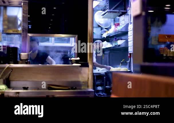 Chefs cooking in a bustling Hong Kong kitchen Stock Video Footage - Alamy