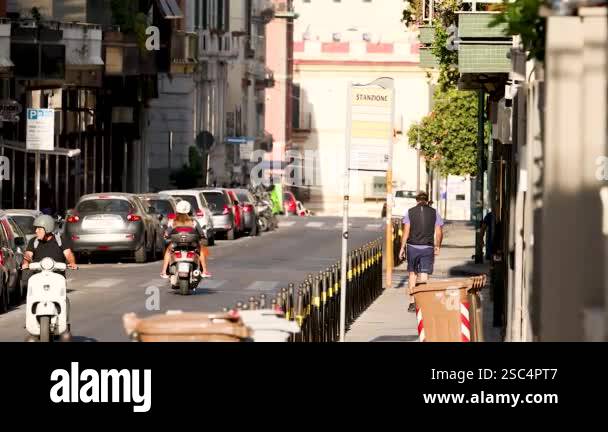 Scooter and pedestrian on a Naples street Stock Video Footage - Alamy