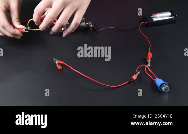 Hands-on experiment with electric circuits and materials Stock Video ...