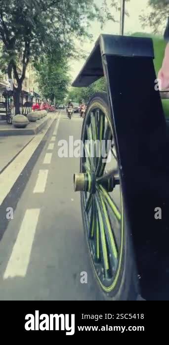 Zooming in wheel of indonesian traditional working horse drawn taxi ...