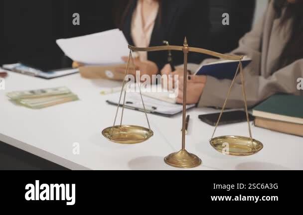 lawyer working with scales, law book and pen at office table in office ...
