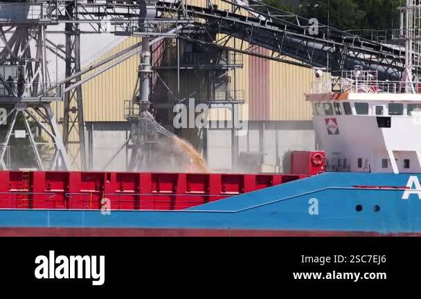 Cargo ship being loaded with materials Stock Video Footage - Alamy