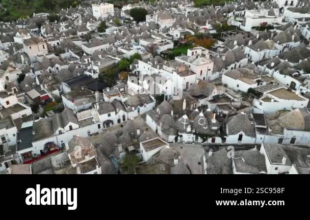 Flying over Alberobello, cultural heritage from above.trulli like a ...