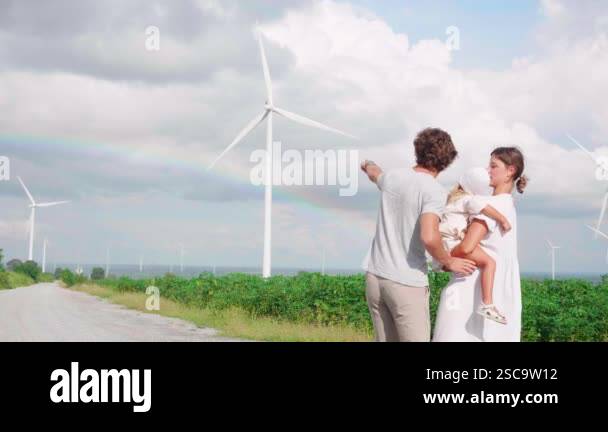 Happiness family walking wind turbine farm while father and mother ...
