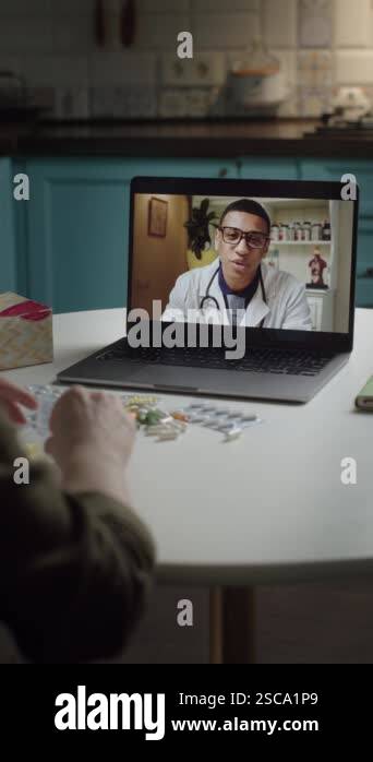 A patient consults with an online doctor from home while reviewing ...