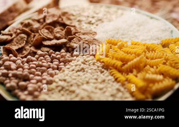 Close-up of assorted carbohydrate-rich foods arranged on a table ...