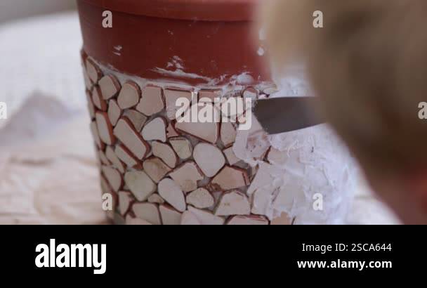 Process of designing broken tile mosaic flower pot. Person decorate ...