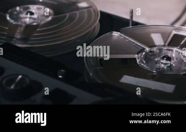 Close-up view of a vintage reel-to-reel tape recorder with its reels ...