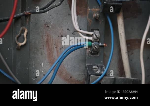 A close-up shot of the internal wiring of a metal electric panel with ...