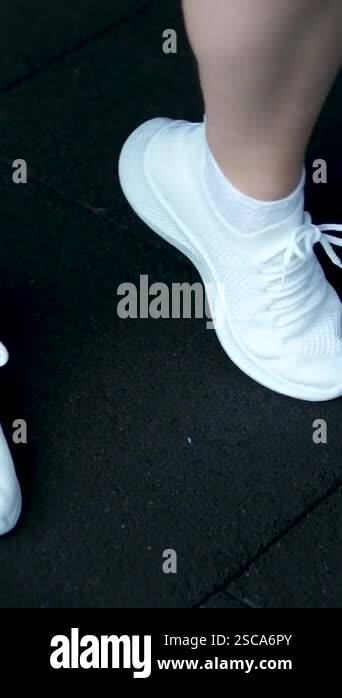 circular foot movements. stretch the joints of the legs Young woman ...