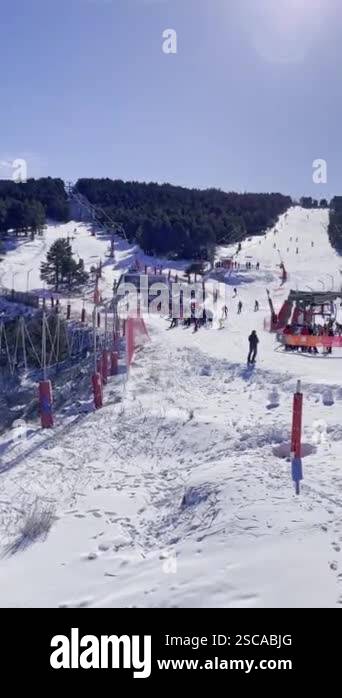 Skiers slalom down a snowy slope at the Valdelinares ski resort in ...