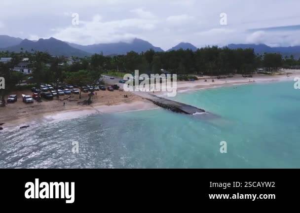 A slow aerial pan of a Kailua beach on Oahu island, Hawaii, featuring ...
