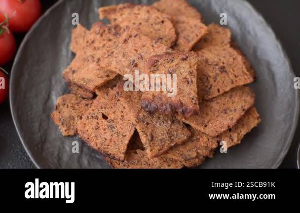 Crispy homemade brown bread chips with seeds and grains, salt, spices ...